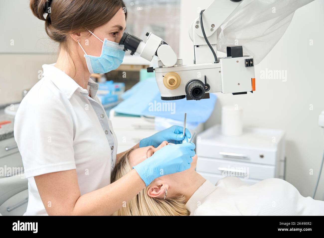Adult lady doctor cleaning the patient in the office Stock Photo - Alamy