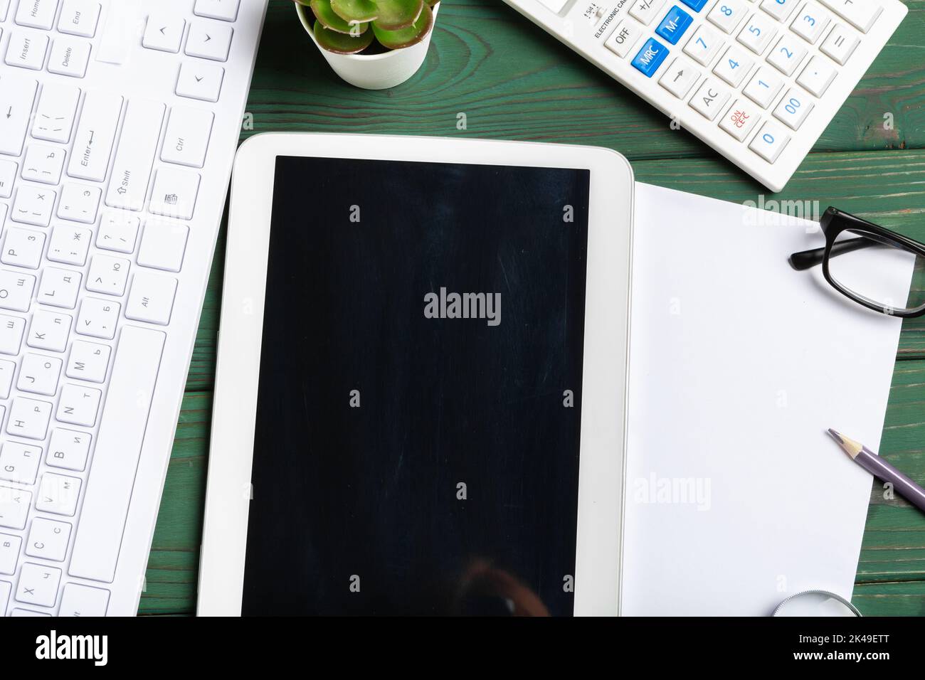 Top view of wooden desktop with glasses and stationery items close up ...