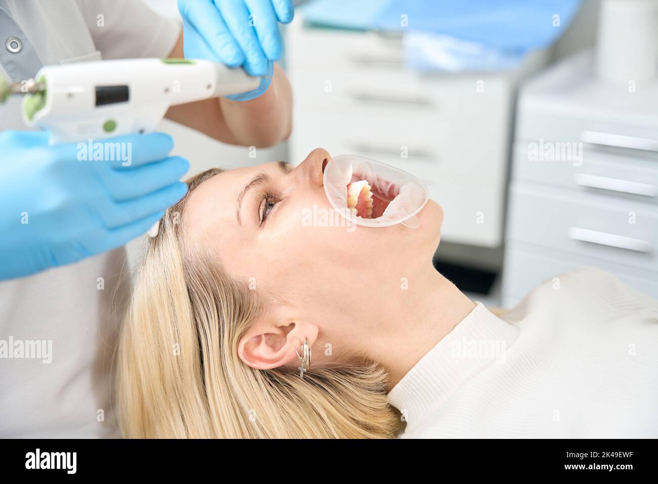Caucasian female patient with open mouth lies on the couch Stock Photo ...