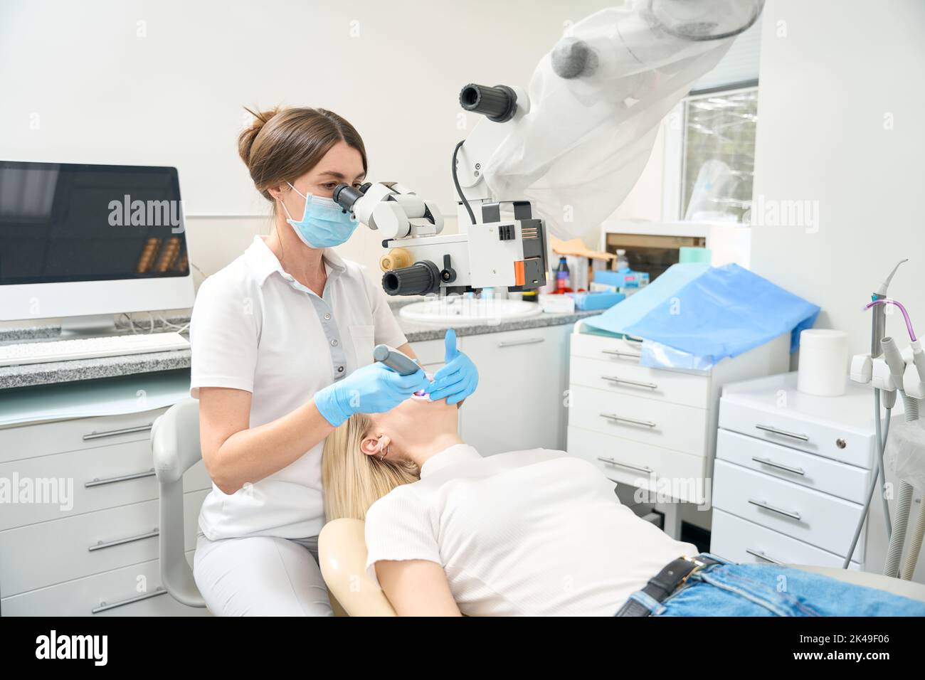 Patient lies on the couch while brushing her teeth Stock Photo - Alamy