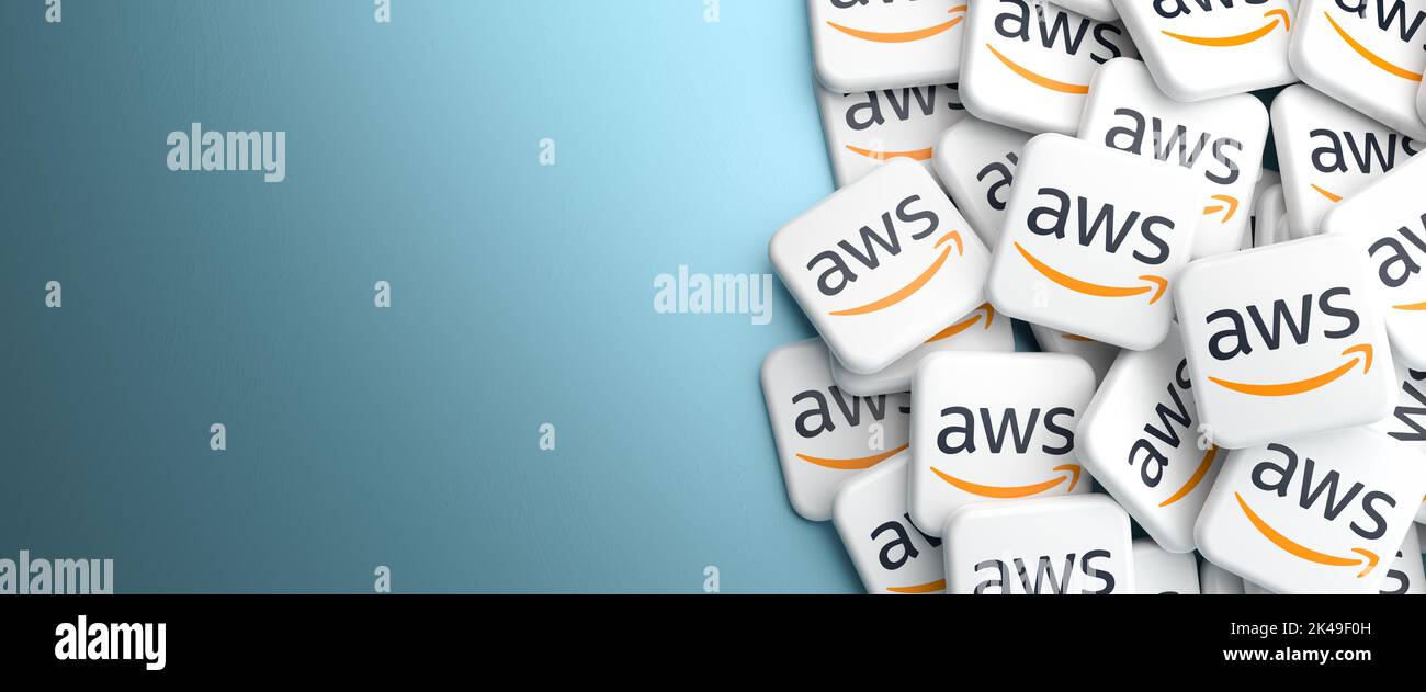 Logos of the Amazon cloud services AWS on a heap on a table. Web banner format with copy space ...