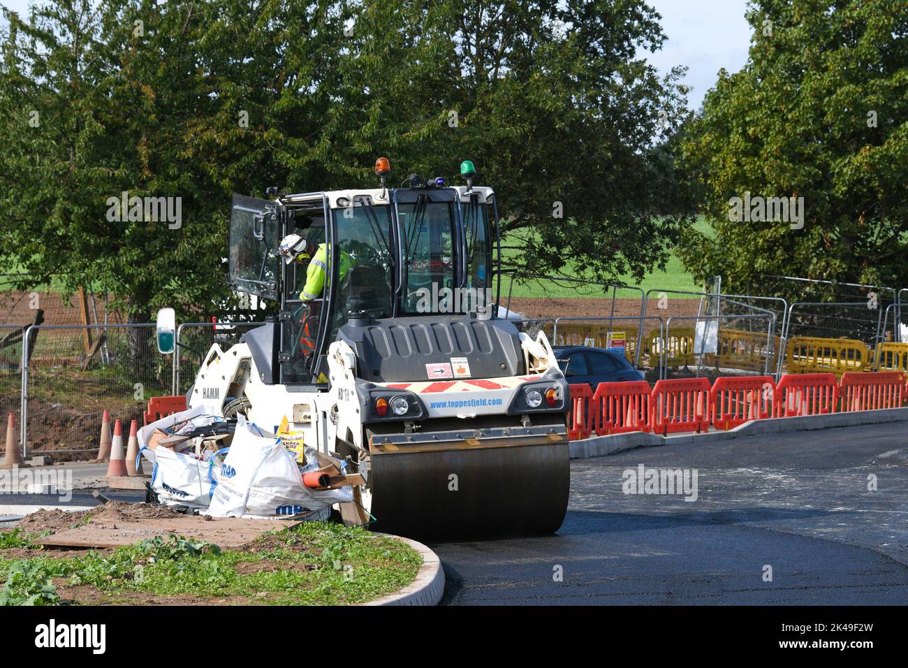 road roller rolling tarmac on a new road Stock Photo - Alamy