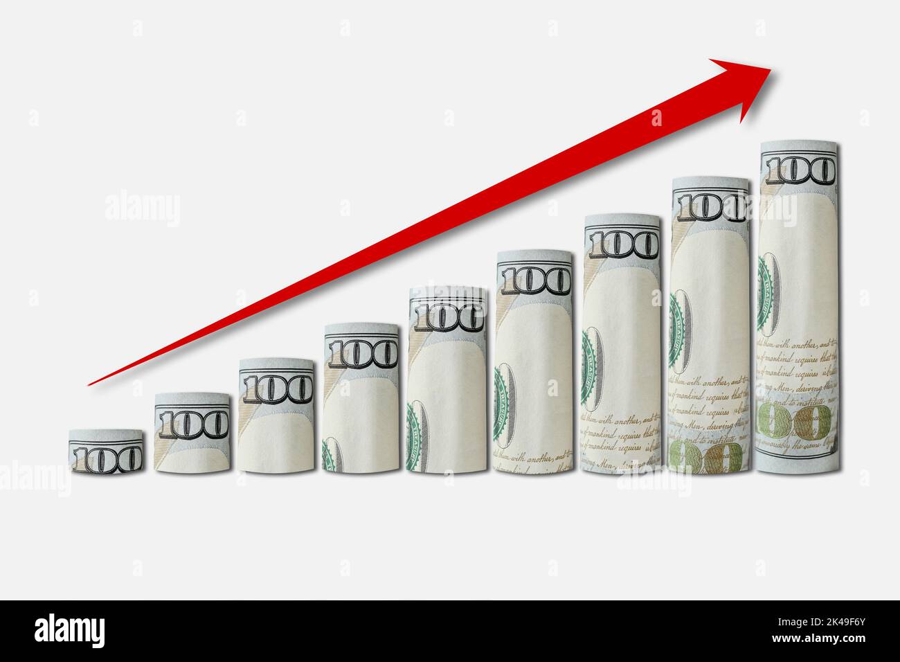Rolled up dollar bills in an ascending chart with a red up arrow ...