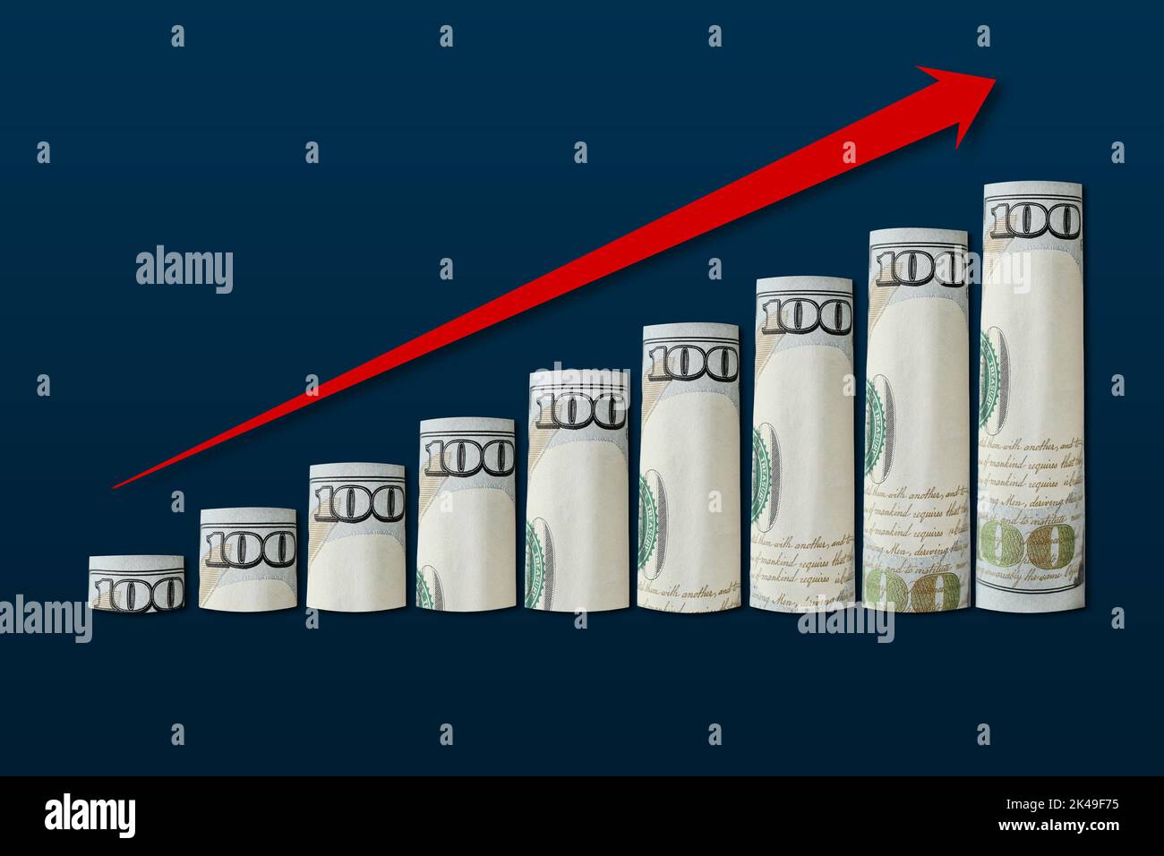 Rolled up dollar bills in an ascending chart with a red up arrow ...