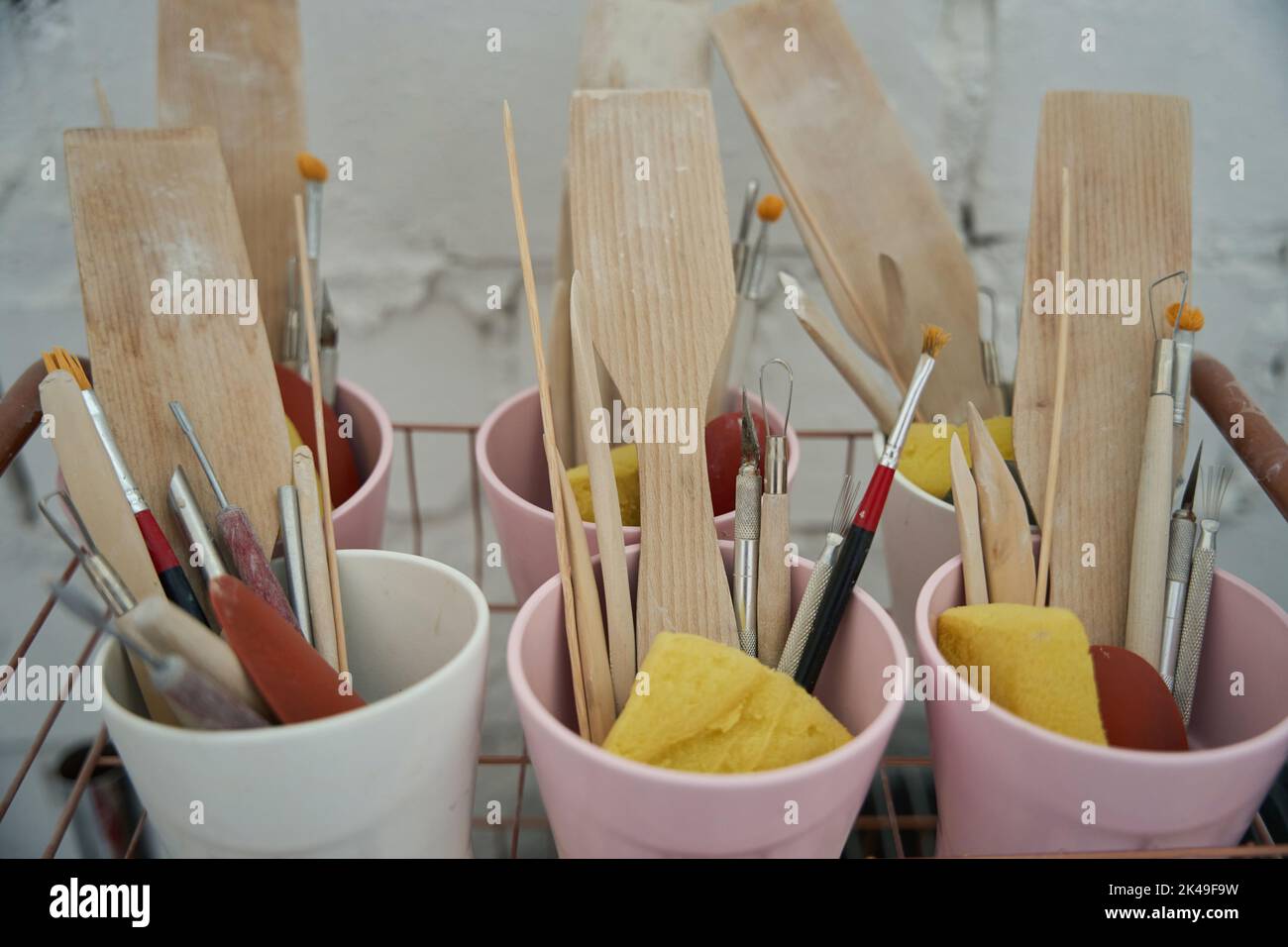 Sets of special tools for processing pottery in cups Stock Photo - Alamy