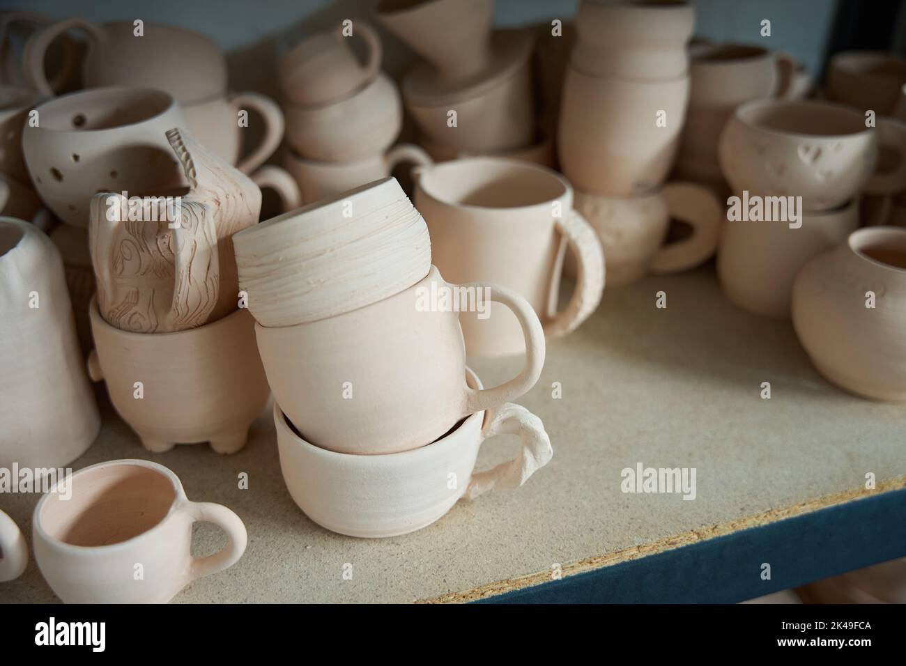 Raw clay cups stand on a shelf Stock Photo - Alamy