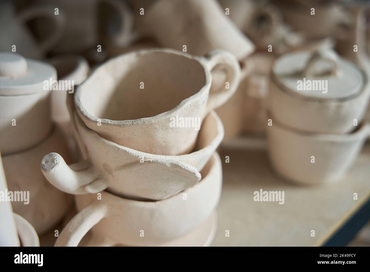 Clay cups and bowls are on the rack Stock Photo - Alamy