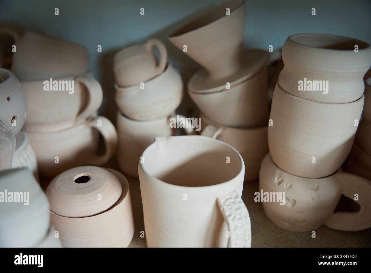 Small pottery items stand on a shelf Stock Photo - Alamy