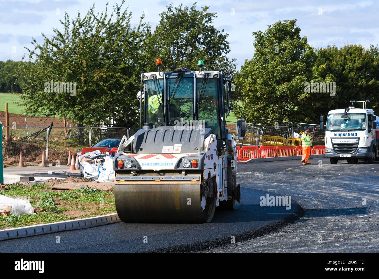 road roller rolling tarmac on a new road Stock Photo - Alamy