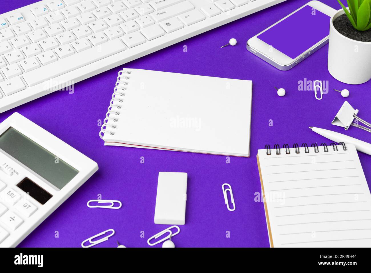 Composition of office lifestyle items on purple background, computer ...