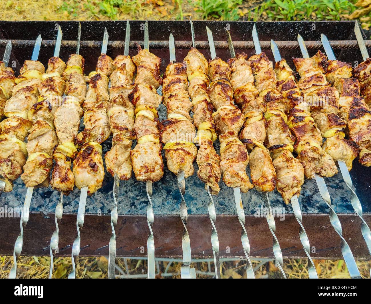 Cooking shish kebab on grill. Process of cooking meat in grill ...