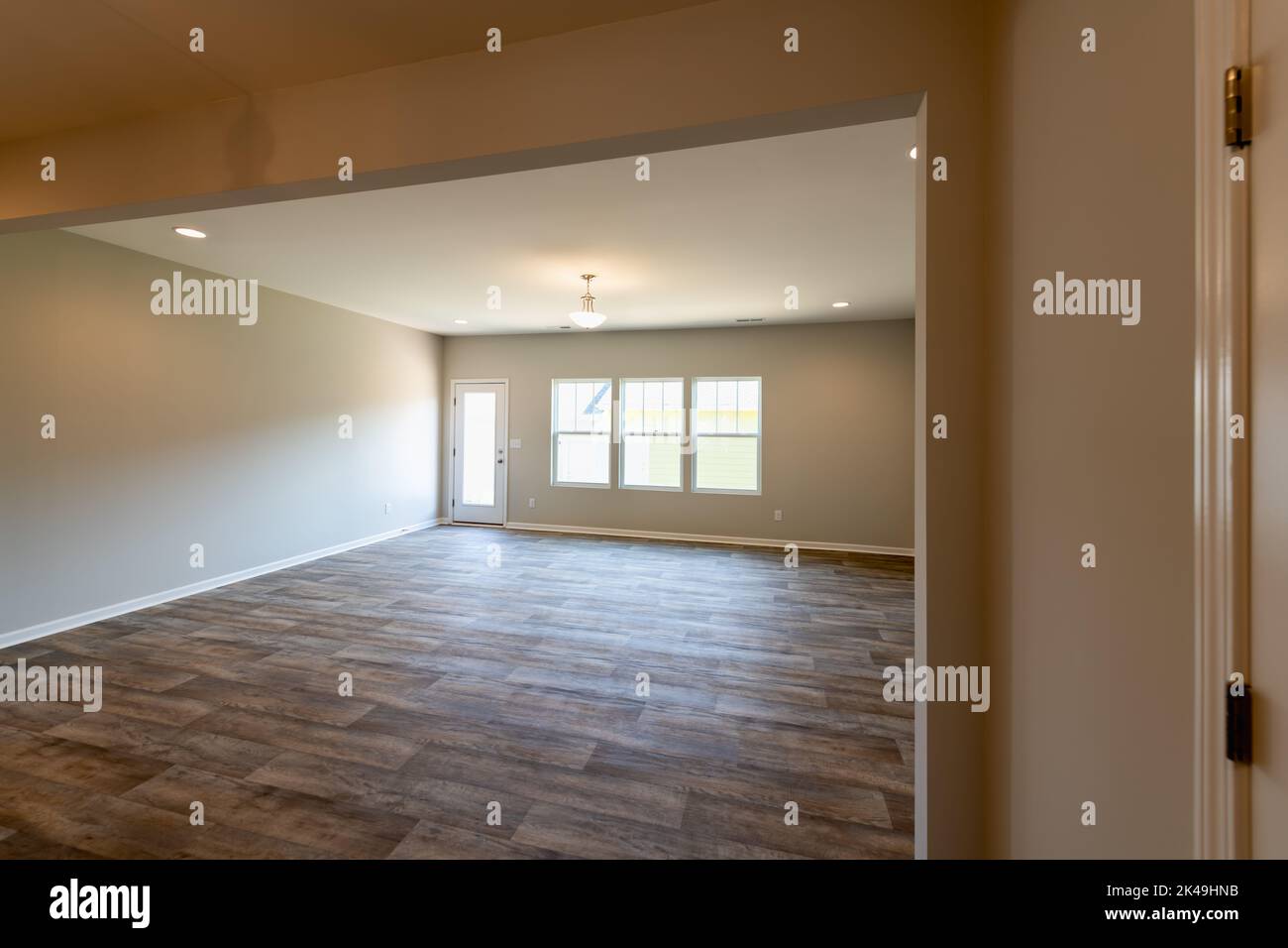 Empty dinning room in a townhouse with ceiling fan, a door, and window ...