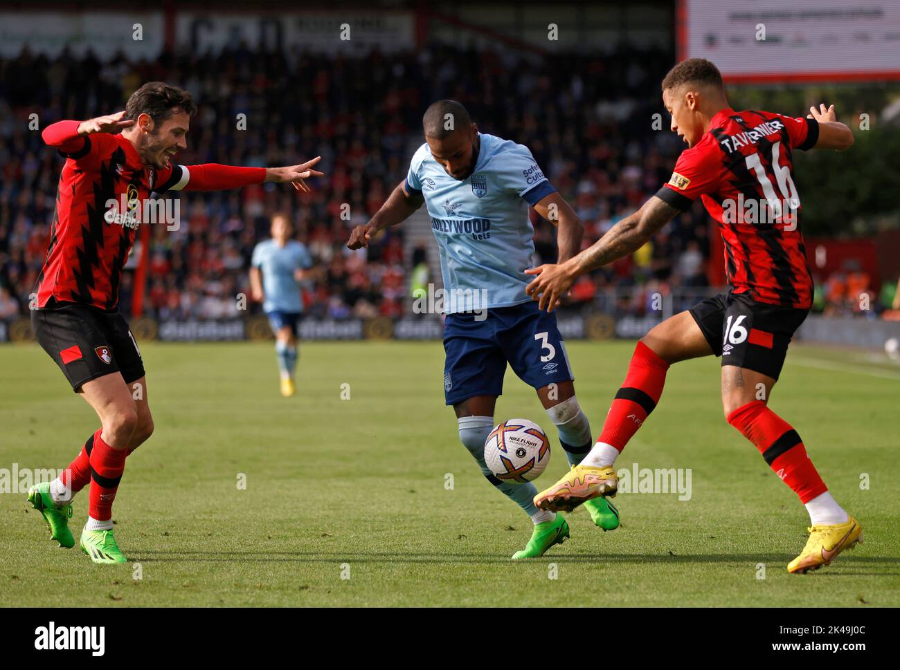 Brentford's Rico Henry (centre) in action with Bournemouth's Adam Smith ...