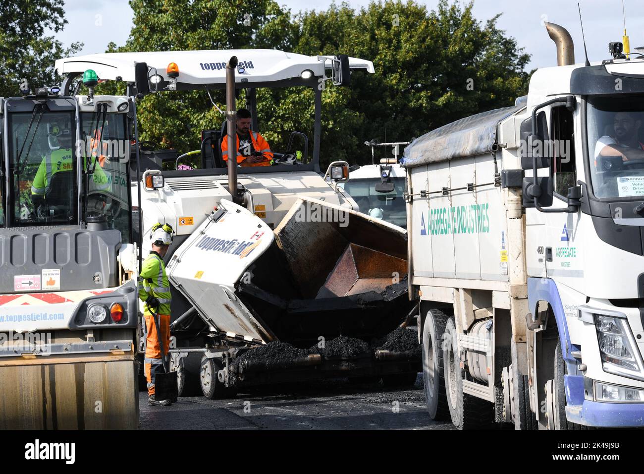 asphalt paver laying tarmac on a new road Stock Photo - Alamy