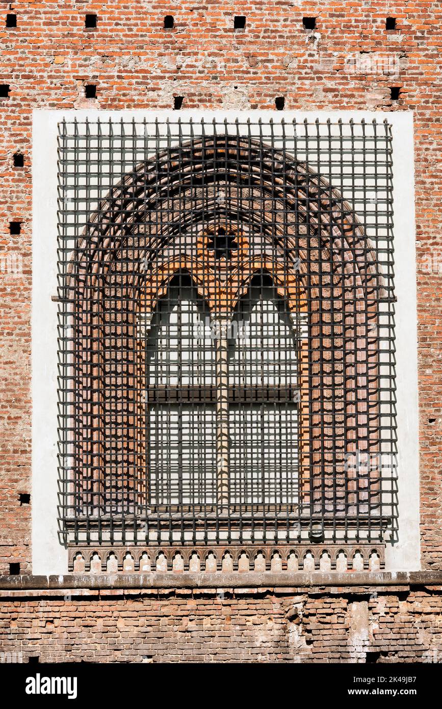 Detail of an ancient window with grating in wrought iron of the Sforza ...