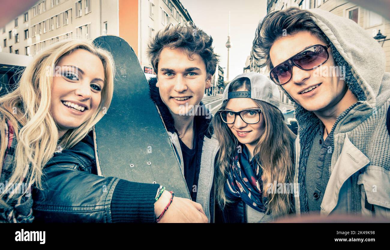 Young hipster best friends taking a selfie in urban city context ...