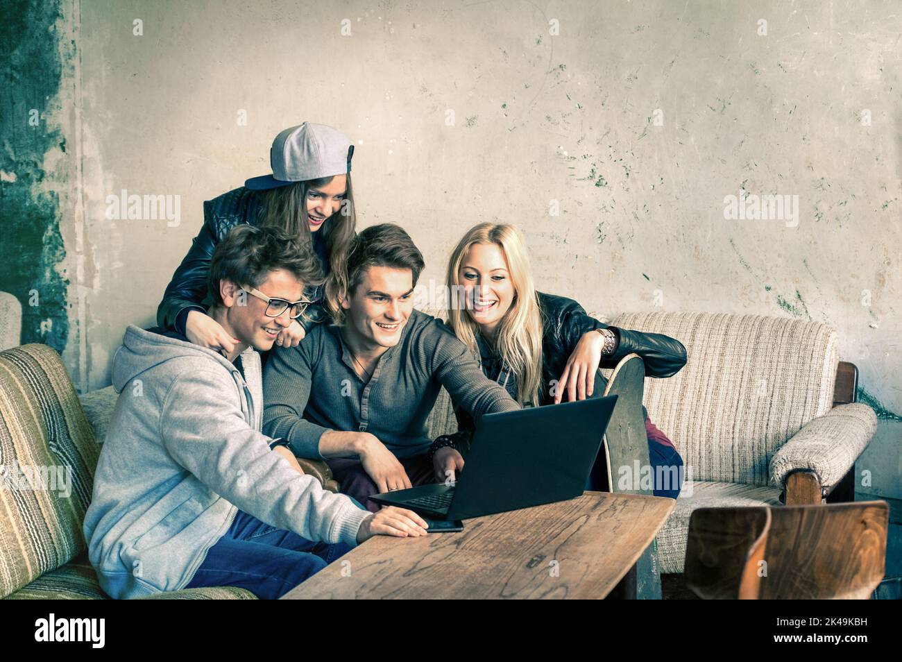 Group of young hipster best friends with computer laptop in urban ...
