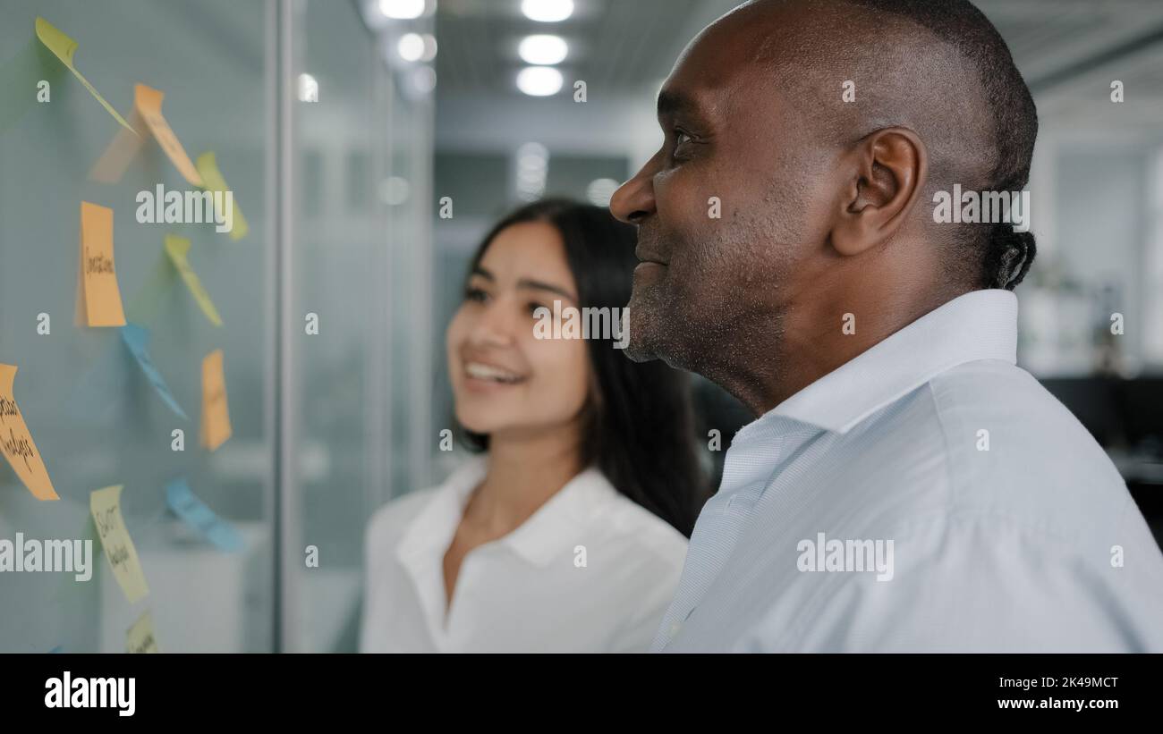 Corporate team business partners colleagues look at paper memo stickers ...