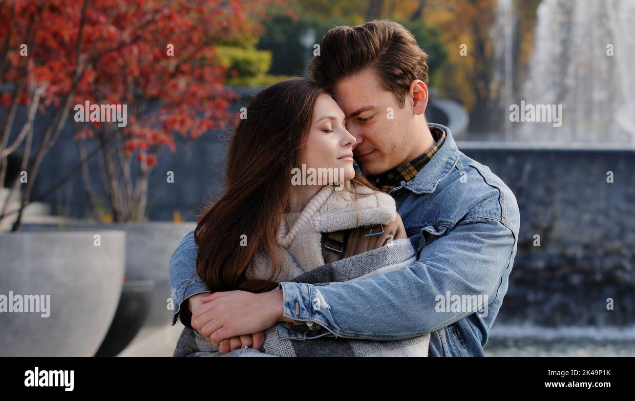 Caucasian couple lovers partners stand background of city fountain ...
