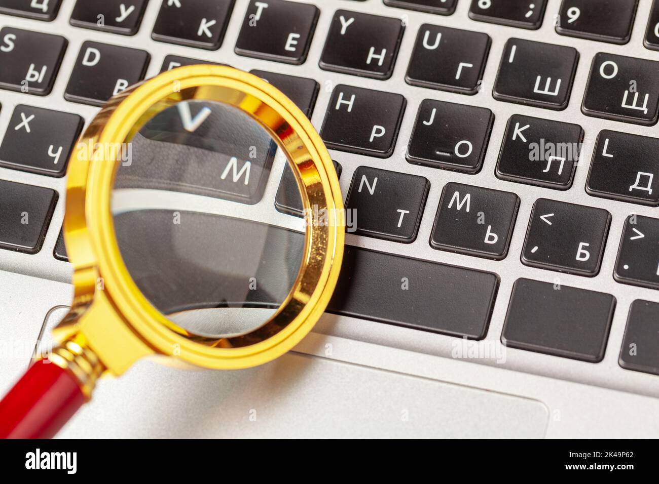 Laptop computer keyboard with magnifying glass, concept of search Stock ...