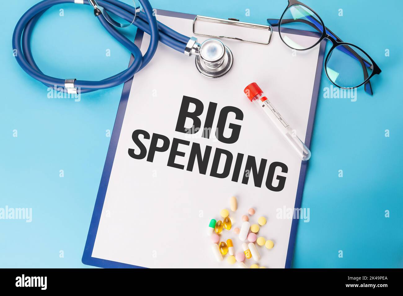Words Big spending Tablet. Stethoscope, paper with Big spending text on ...