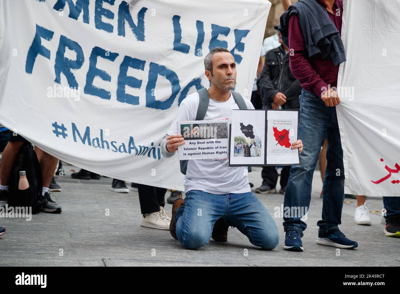 Protesters display placards during a rally calling for freedom in Iran ...