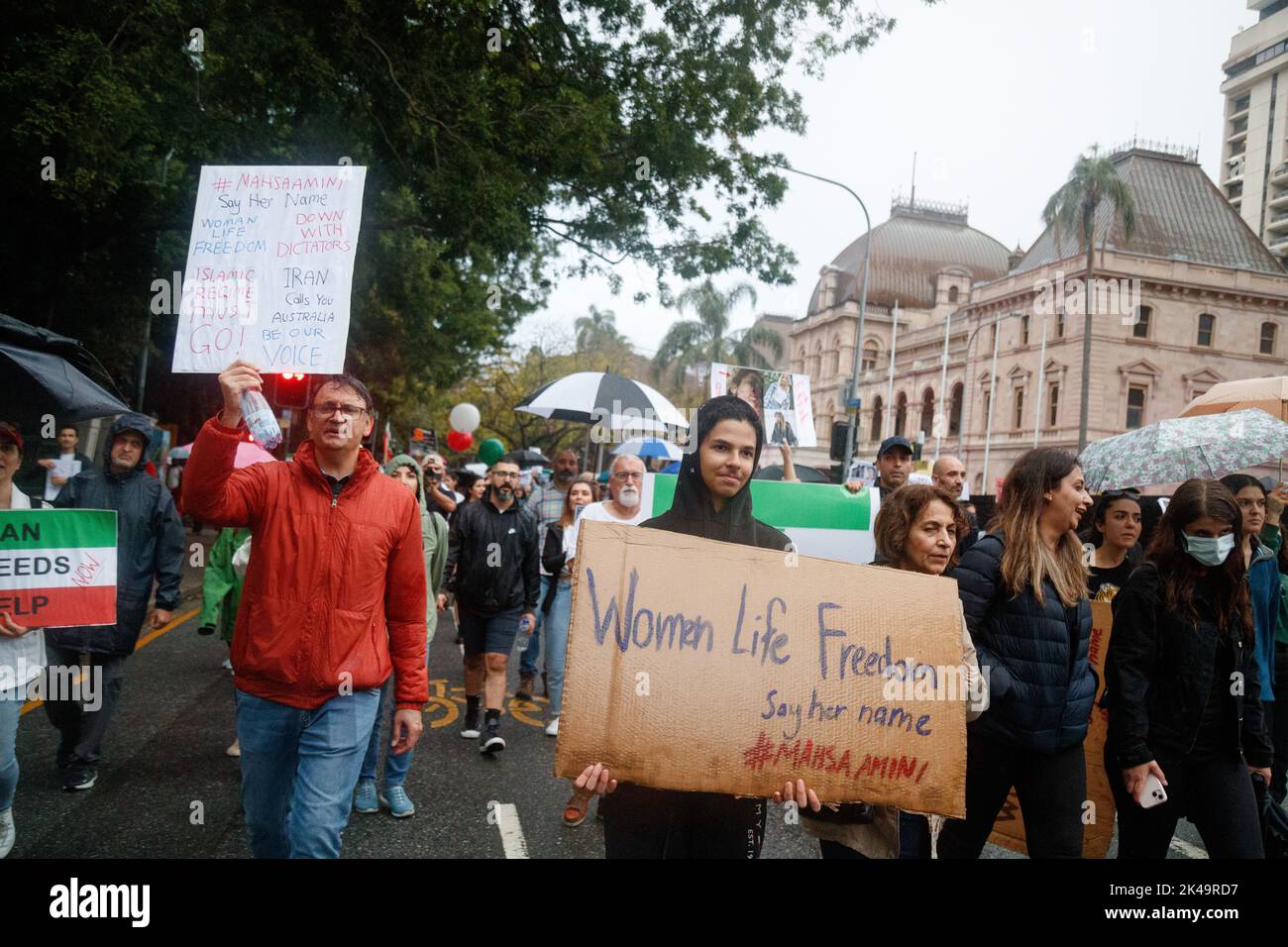 Protesters carry placards and banners during a rally calling for ...