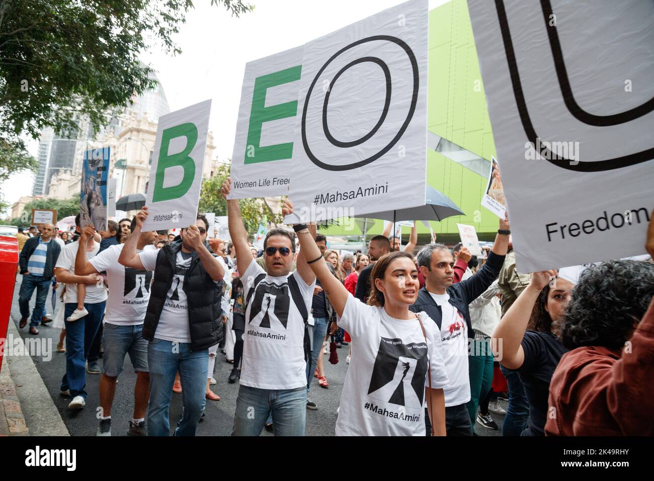 Protesters carry placards and banners during a rally calling for ...