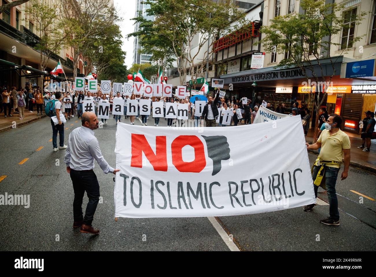 Protesters carry placards and banners during a rally calling for ...