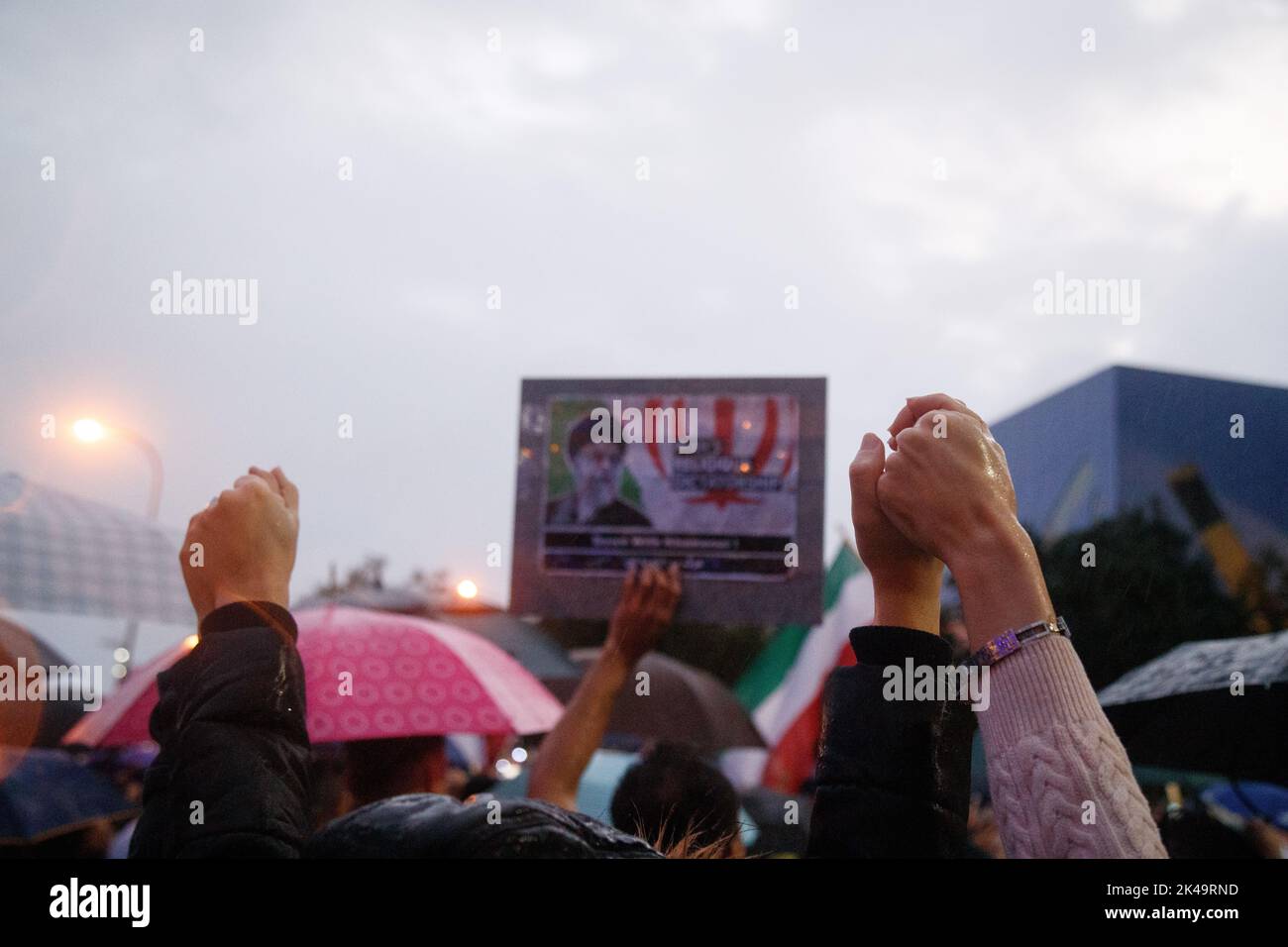 Protesters hold hands in solidarity during a rally calling for freedom ...