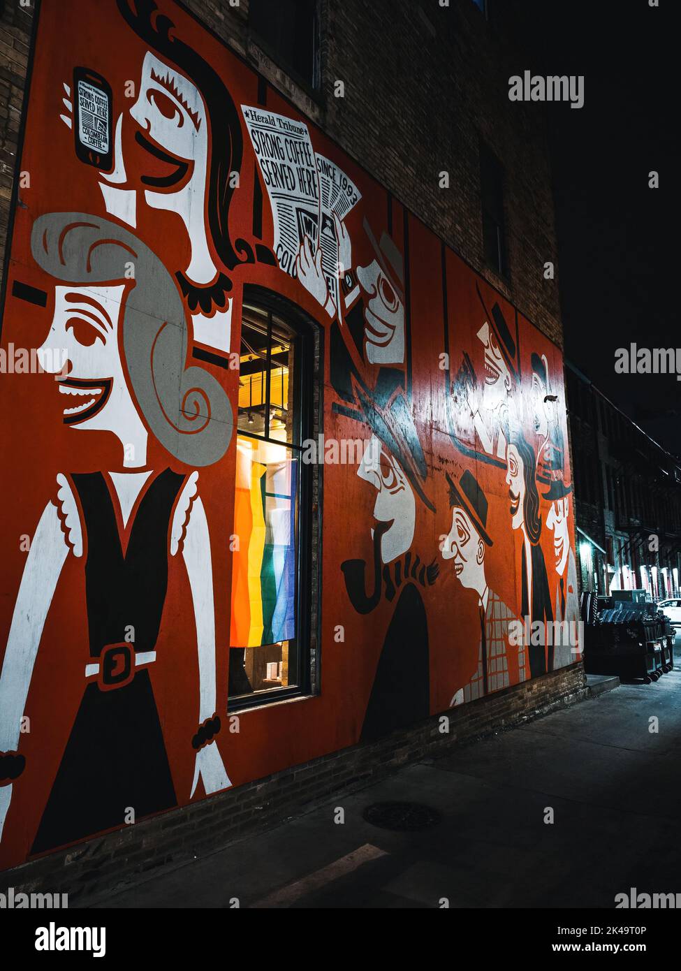 A graffiti street art on a building at night Stock Photo - Alamy