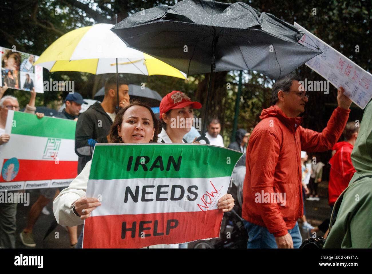Protesters carry placards and banners during a rally calling for ...