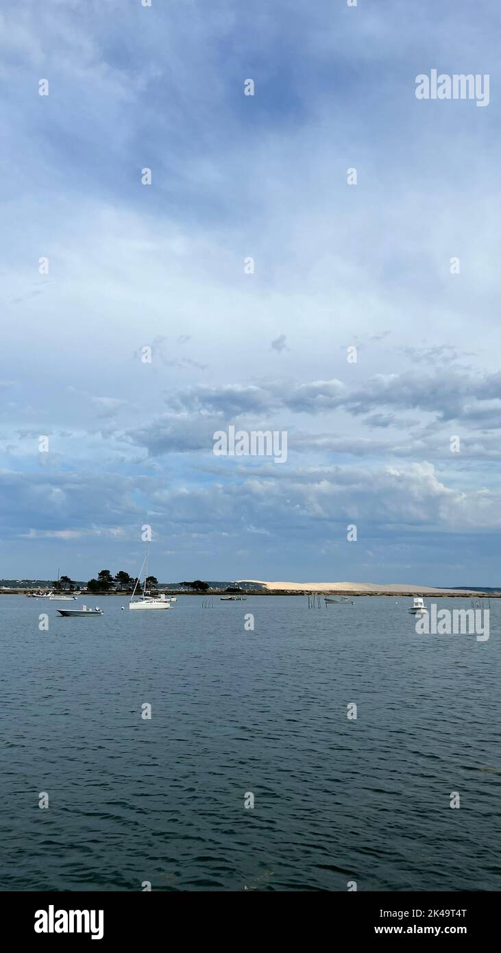 A vertical shot of boats in the calm lake against a cloudy sky Stock ...