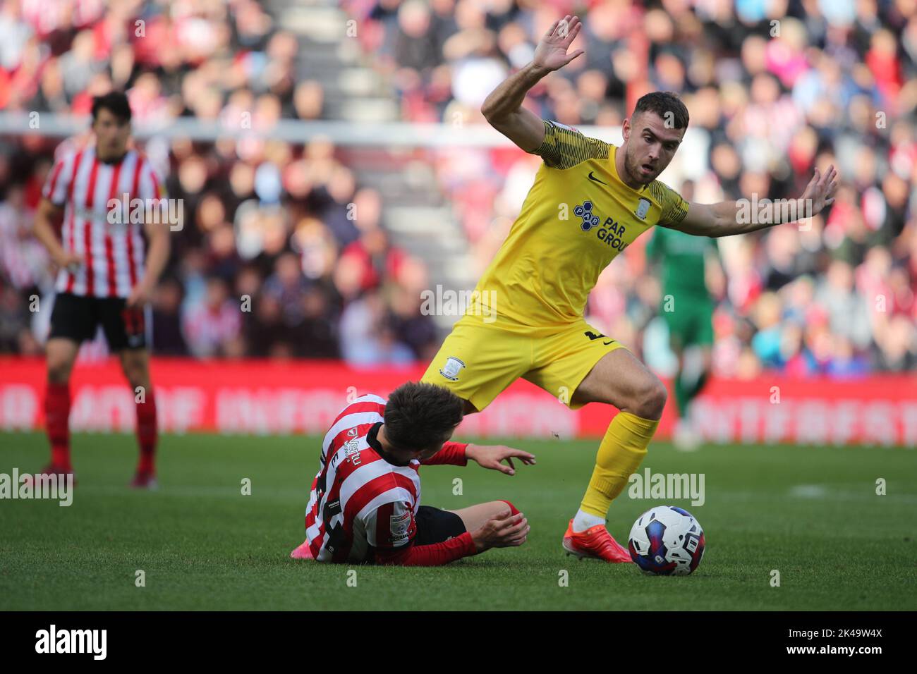Dan Neil #24 of Sunderland tackles Ben Whiteman #4 of Preston during ...