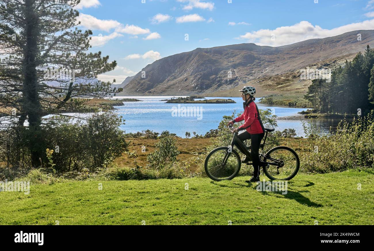 nice senior woman on mountain bike, cycling at Lough Beagh in the ...