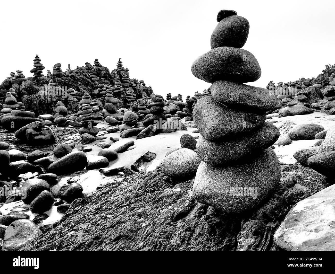 A grayscale of a pile of stones in a rocky area Stock Photo - Alamy