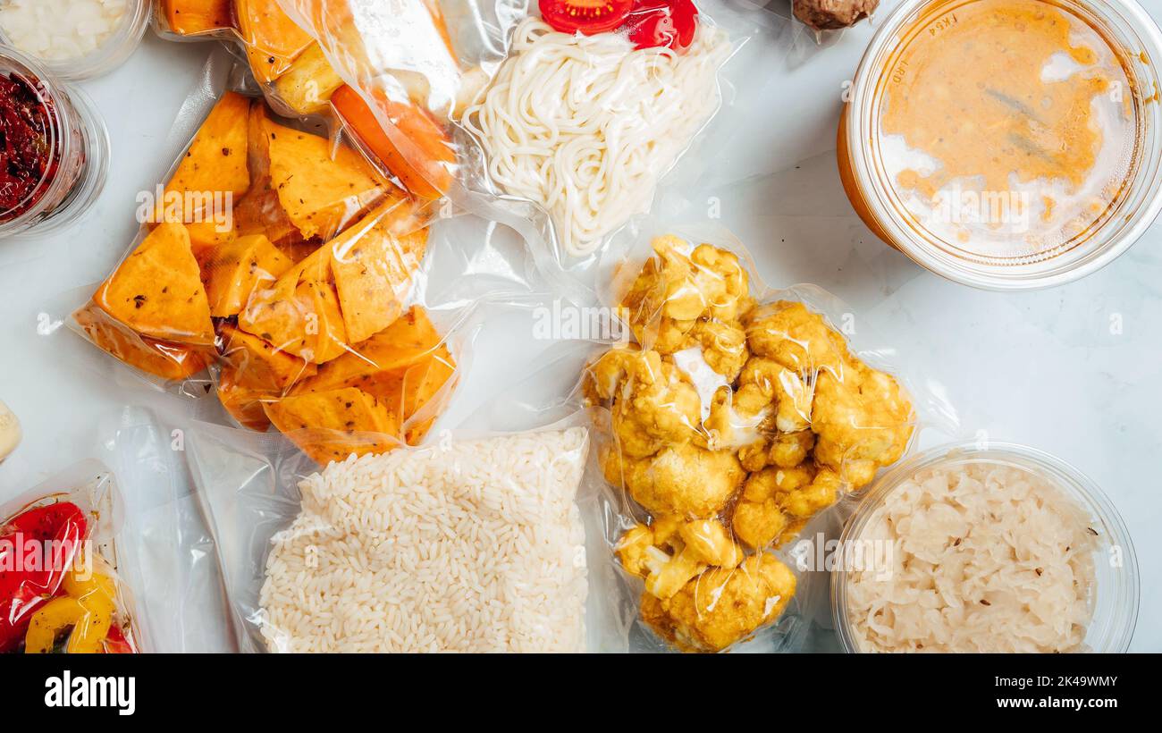 A top view of snacks and servings of food in plastic containers Stock ...