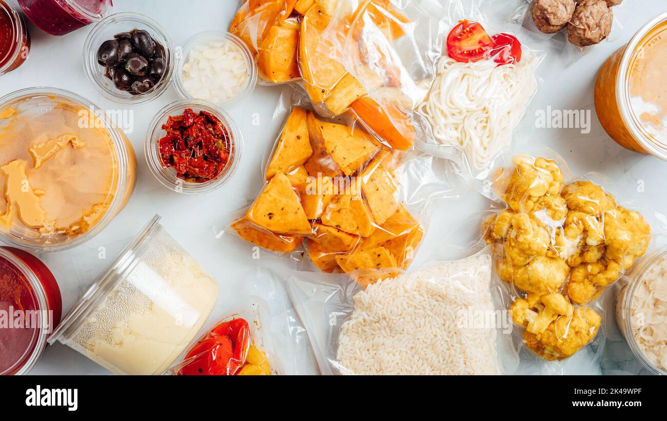 A top view of snacks and servings of food in plastic containers Stock ...