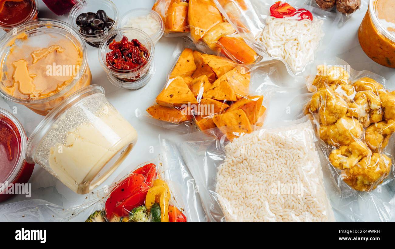 A top view of snacks and servings of food in plastic containers Stock ...
