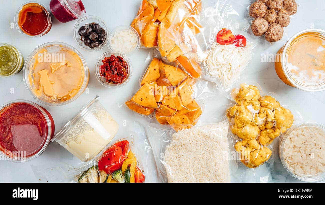 A top view of snacks and servings of food in plastic containers Stock ...
