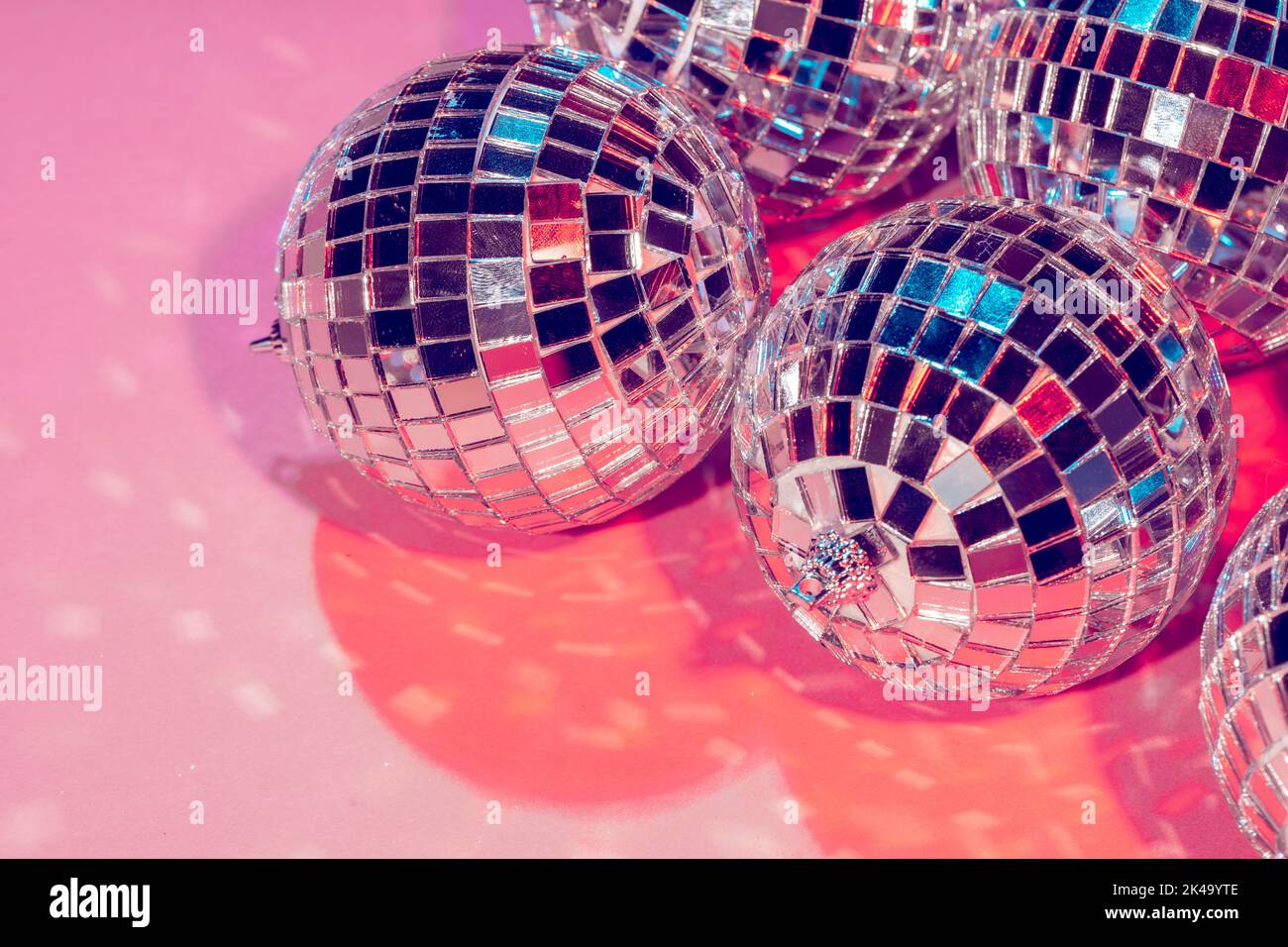 disco balls for decorationof a party on pink background Stock Photo - Alamy