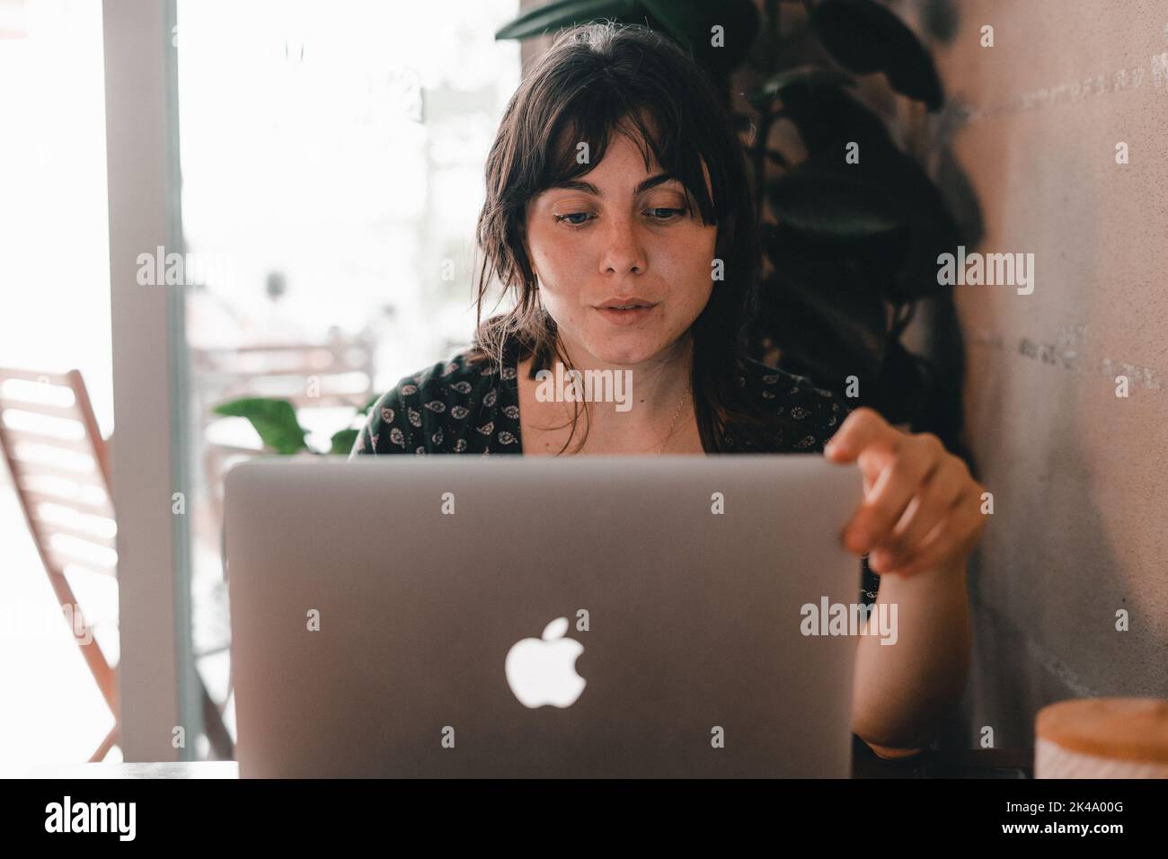 disheveled blue-eyed caucasian girl in front of laptop working at ...