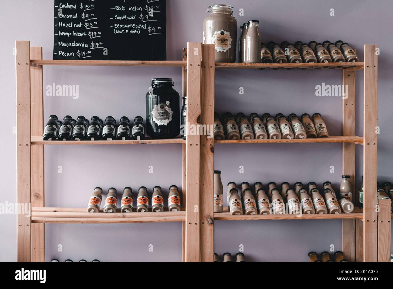 wooden shelf with price list on a blackboard and many clear glass ...