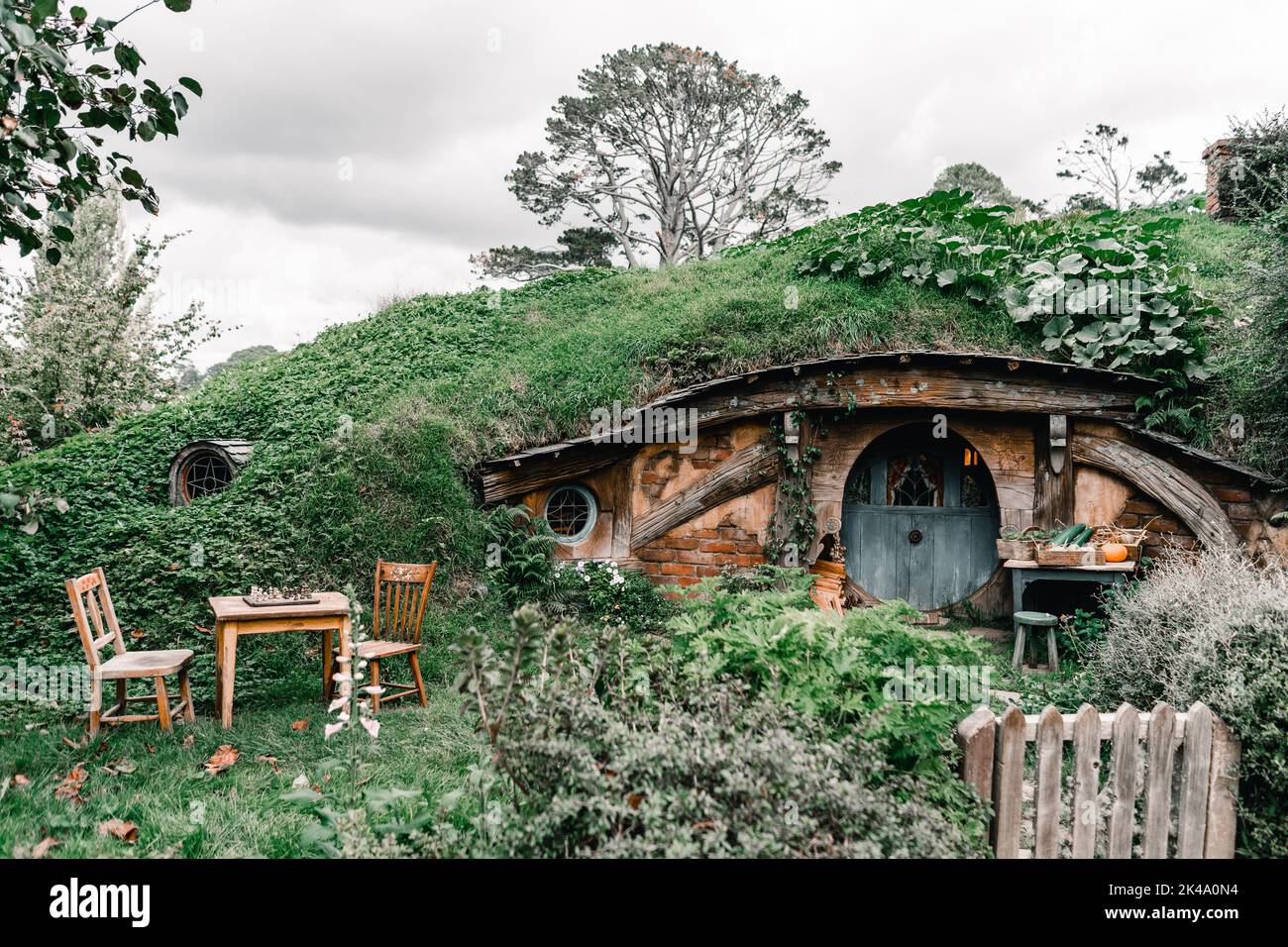 exterior of small wooden house with table chairs and chessboard with ...