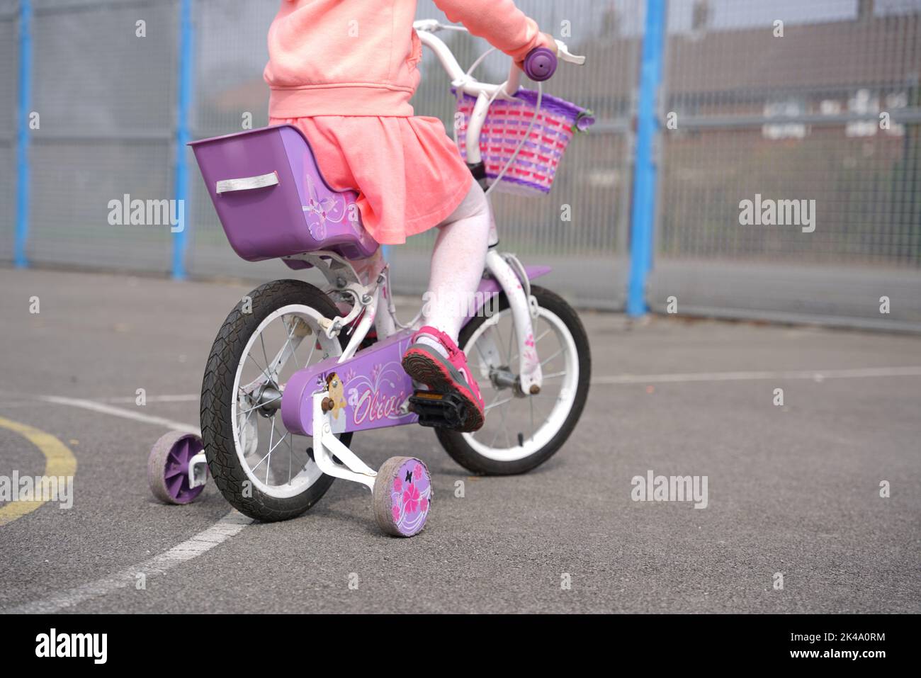 A little girl riding bicycle in a playground Stock Photo - Alamy