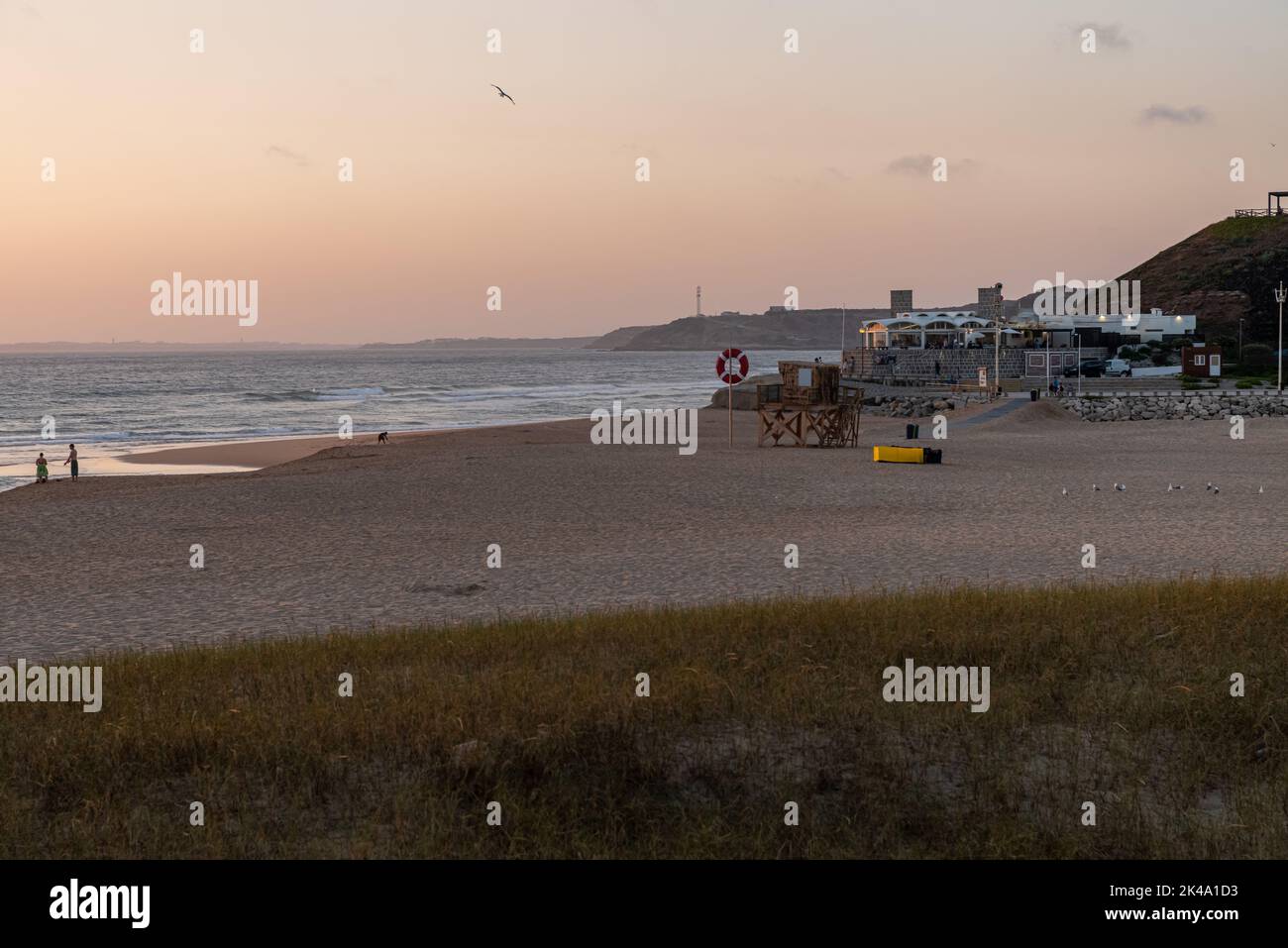 A scenic golden sunset at Areia Branca Beach in Lourinha, Portugal ...