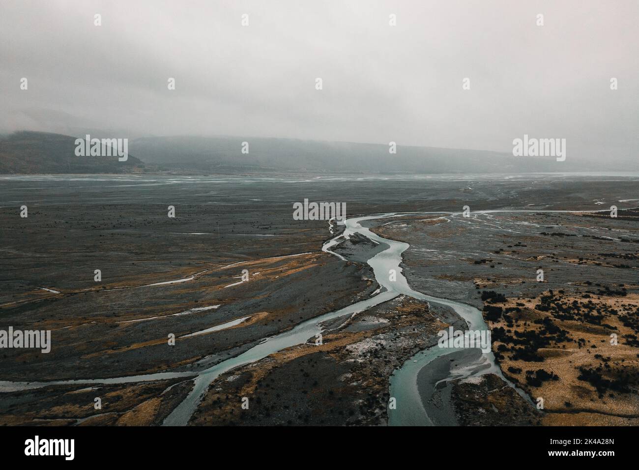tranquil landscape with many narrow strands of water formed by the riverbed in the plain near ...