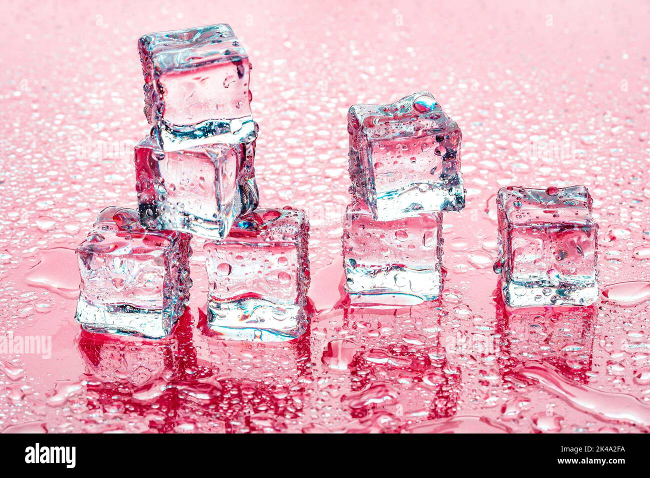 Ice cubes on pink background Stock Photo - Alamy