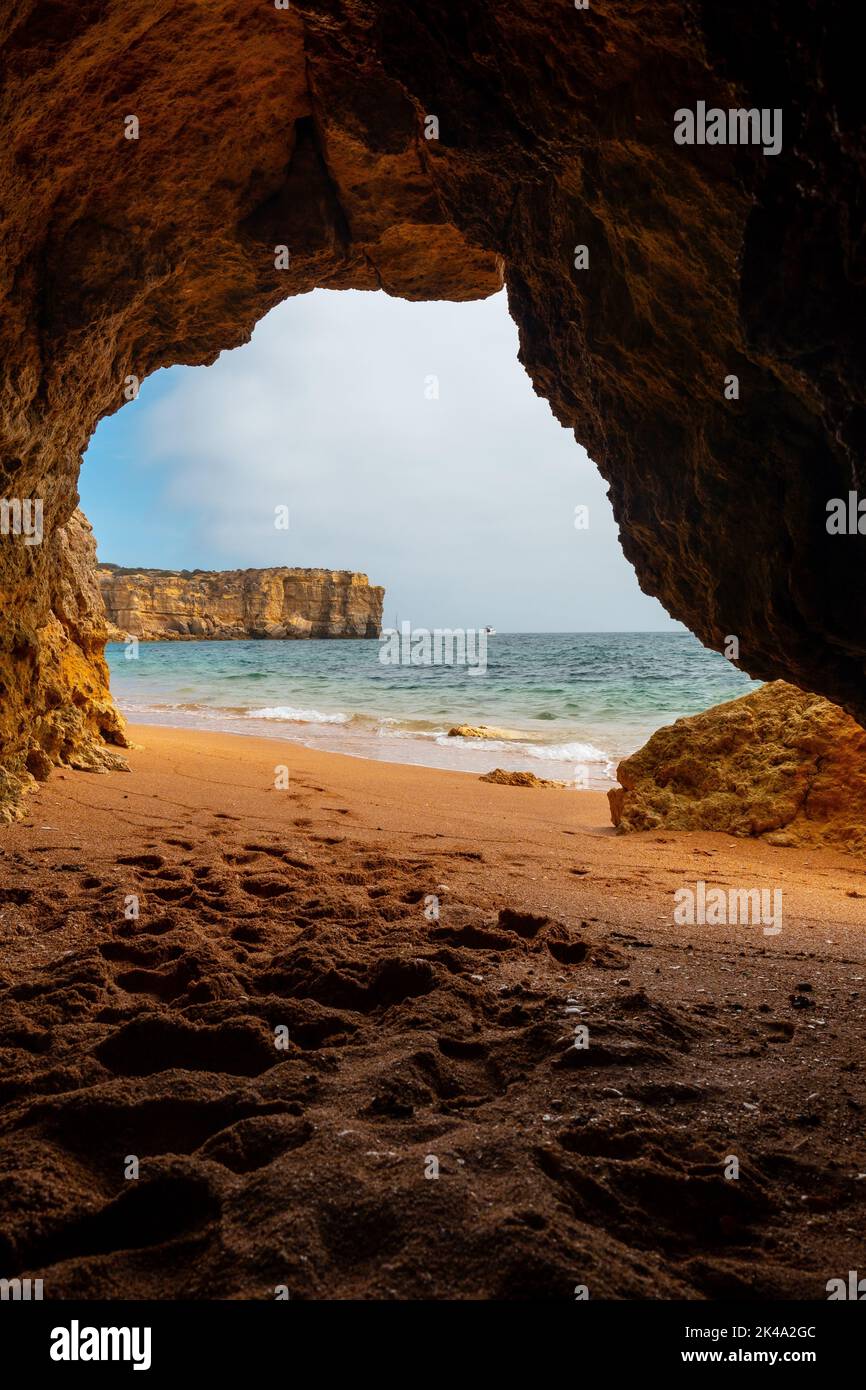 A natural cave in the Algarve on the beach at Praia da Coelha ...