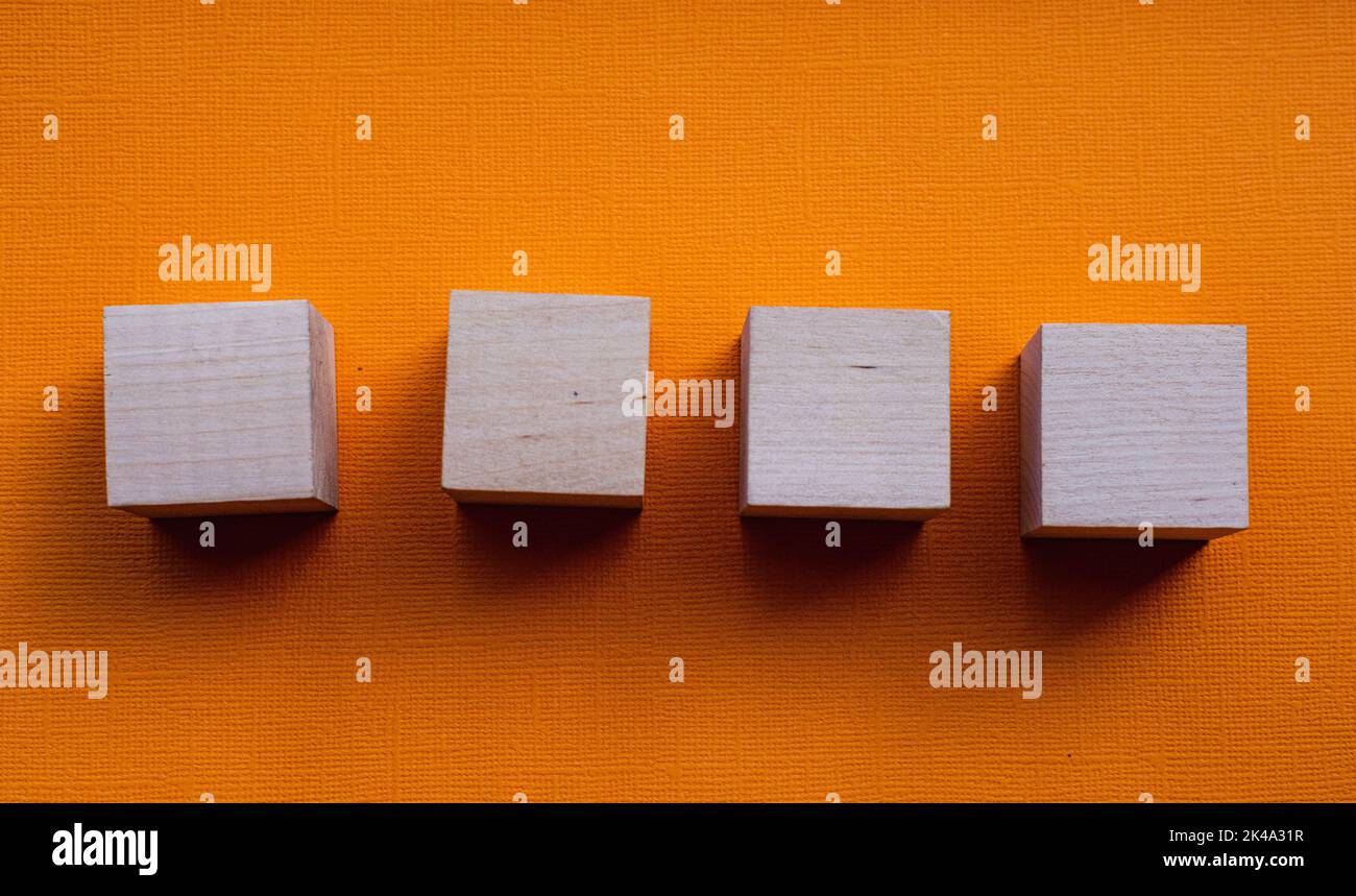 Four wooden cubes on orange background, mockup Stock Photo - Alamy
